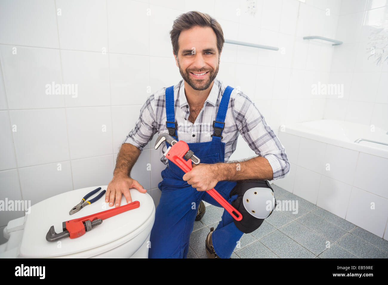 Plumber smiling at the camera Stock Photo - Alamy