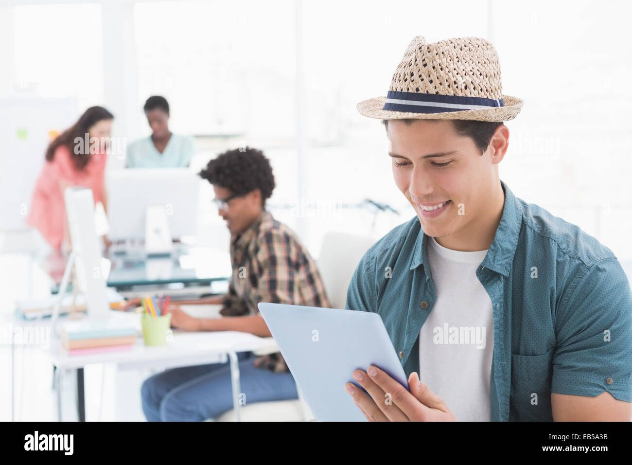 Young creative man using his tablet Stock Photo - Alamy