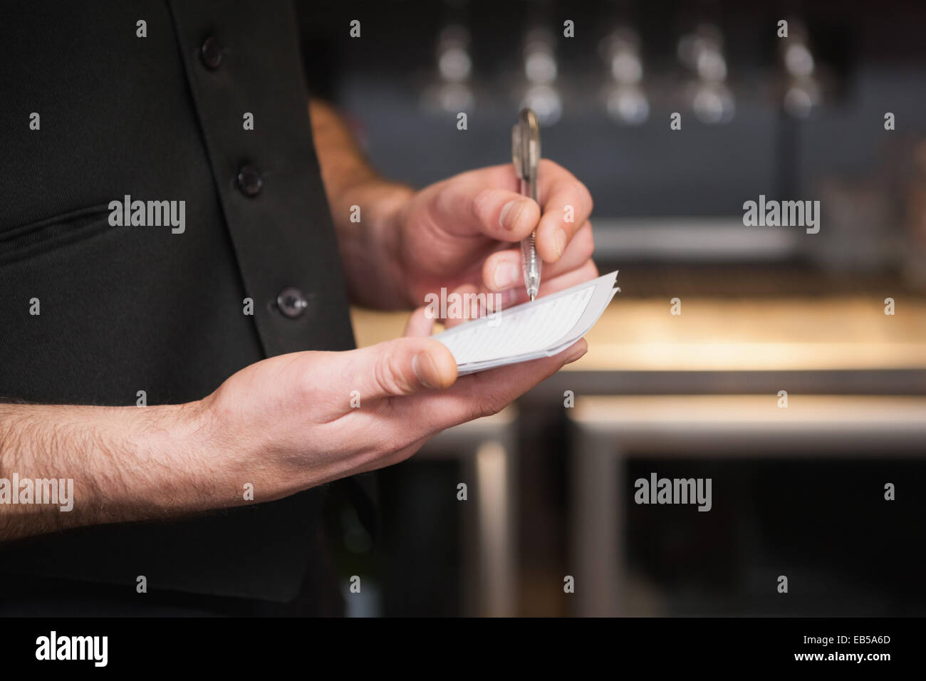 Waiter taking order in his notepad Stock Photo - Alamy
