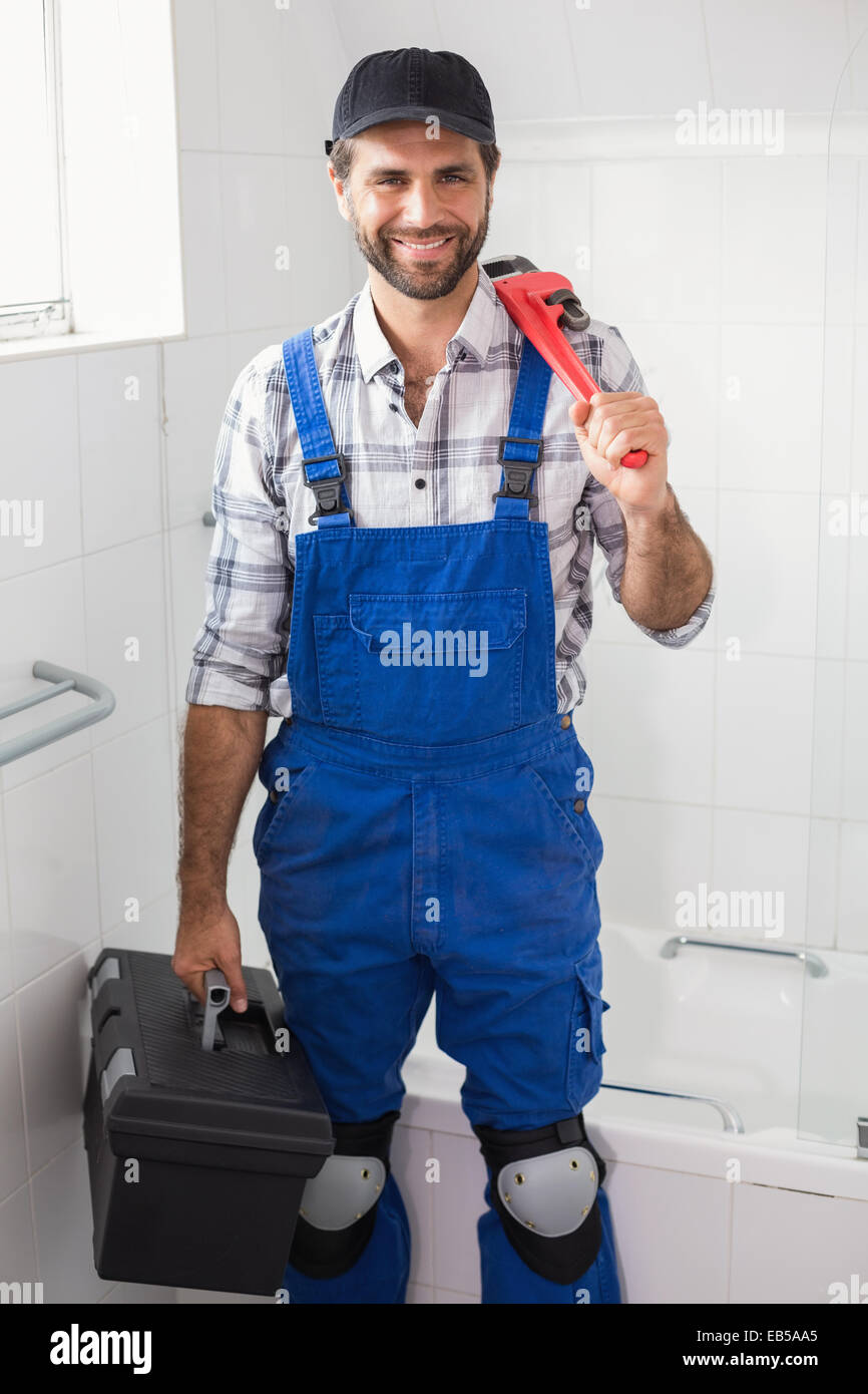 Plumber holding wrench and toolbox Stock Photo - Alamy