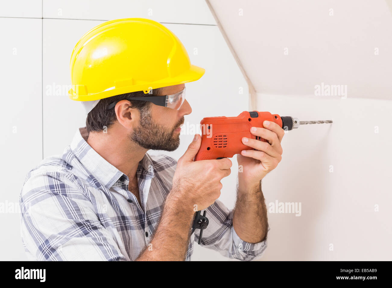 Man using hole in wall hi-res stock photography and images - Alamy