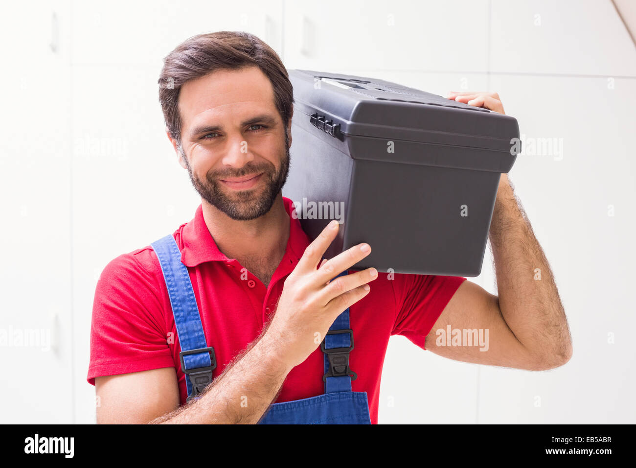 Construction worker holding tool box Stock Photo - Alamy