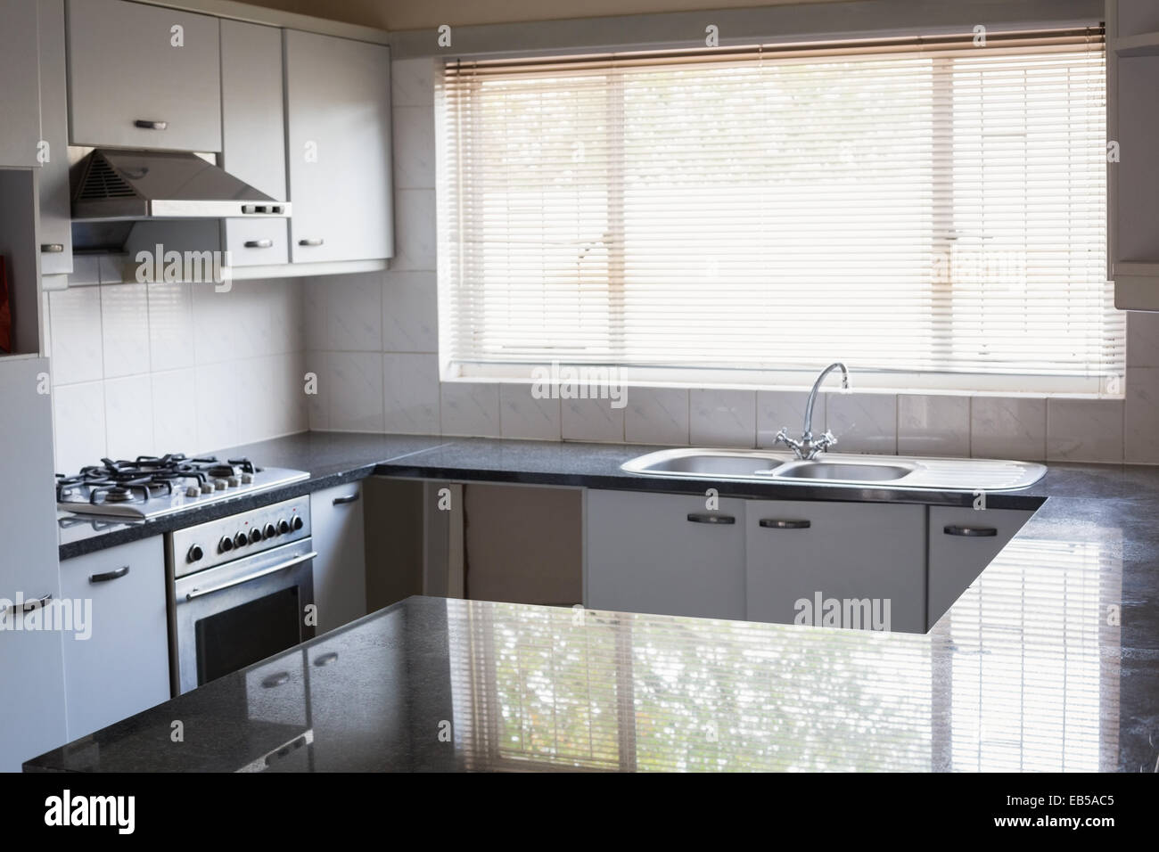 Empty kitchen with white cabinets Stock Photo - Alamy