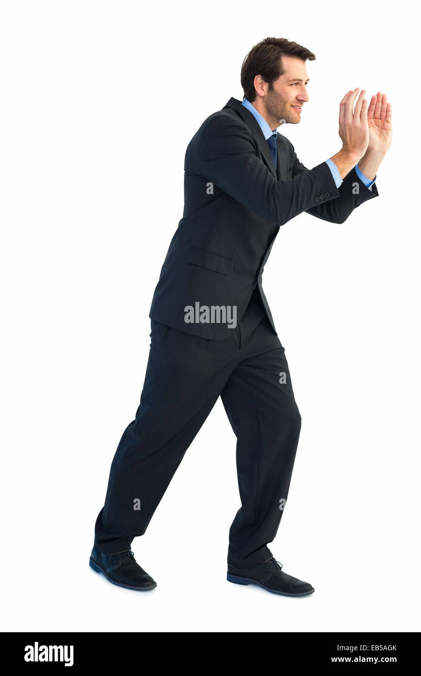 Handsome businessman pushing with hands Stock Photo - Alamy