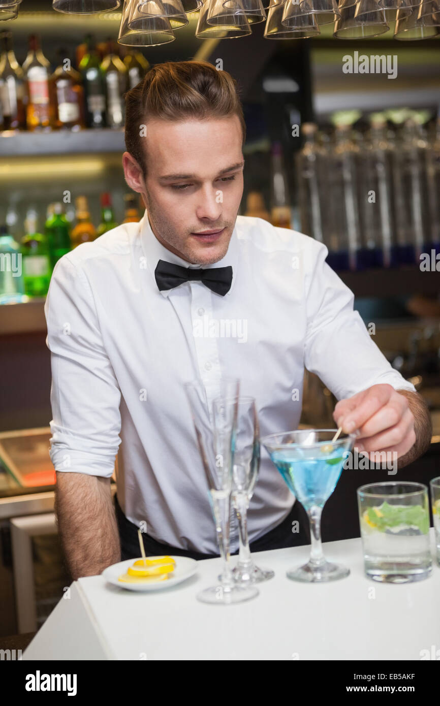Bartender preparing a drink at bar counter Stock Photo - Alamy