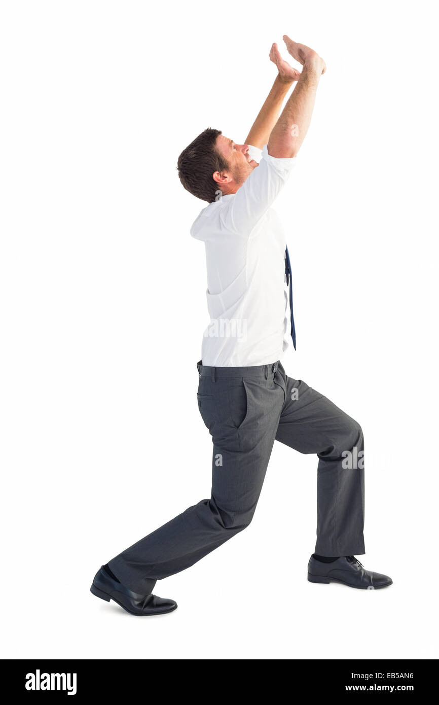 Businessman bending and pushing Stock Photo - Alamy