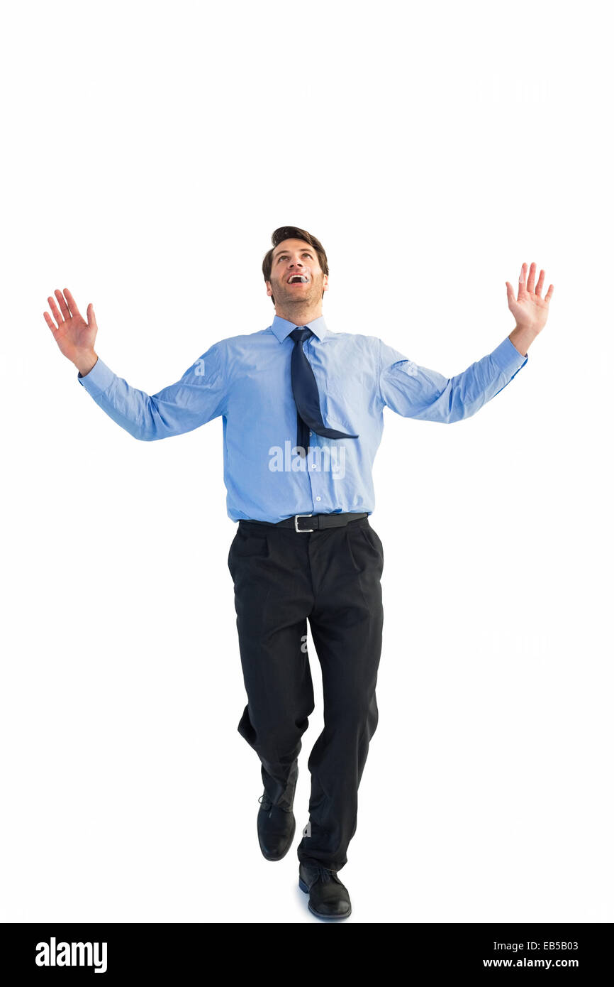 Happy businessman running with hands up Stock Photo - Alamy