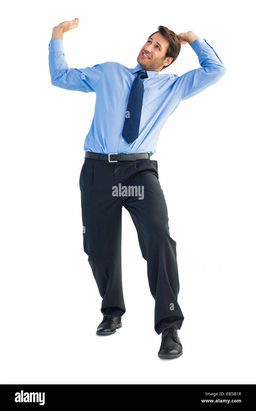 Focused businessman lifting up something heavy Stock Photo - Alamy