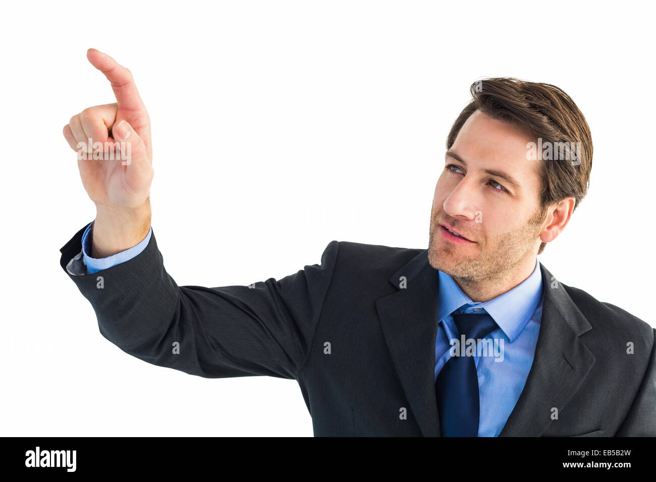 Serious businessman pointing at something Stock Photo - Alamy