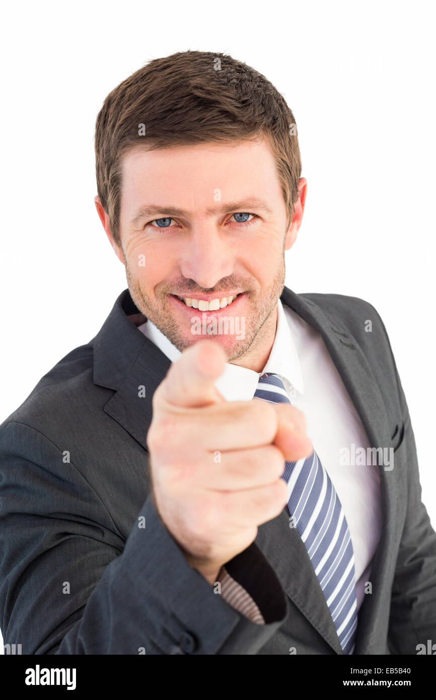 Businessman smiling and pointing Stock Photo - Alamy