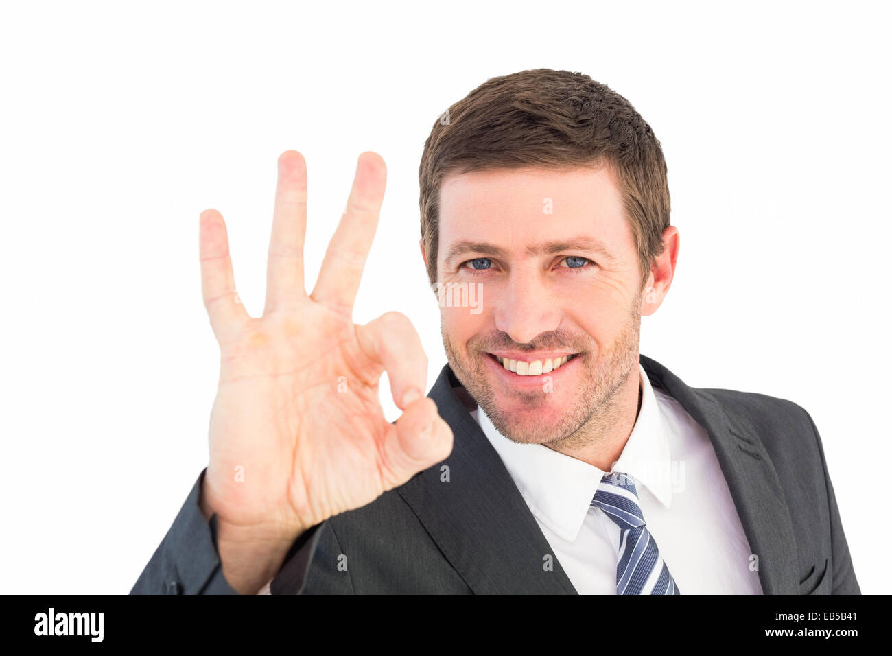 Businessman smiling and making ok sign Stock Photo - Alamy