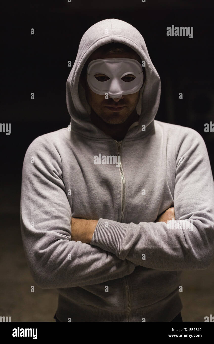 Criminal in mask looking at camera Stock Photo - Alamy