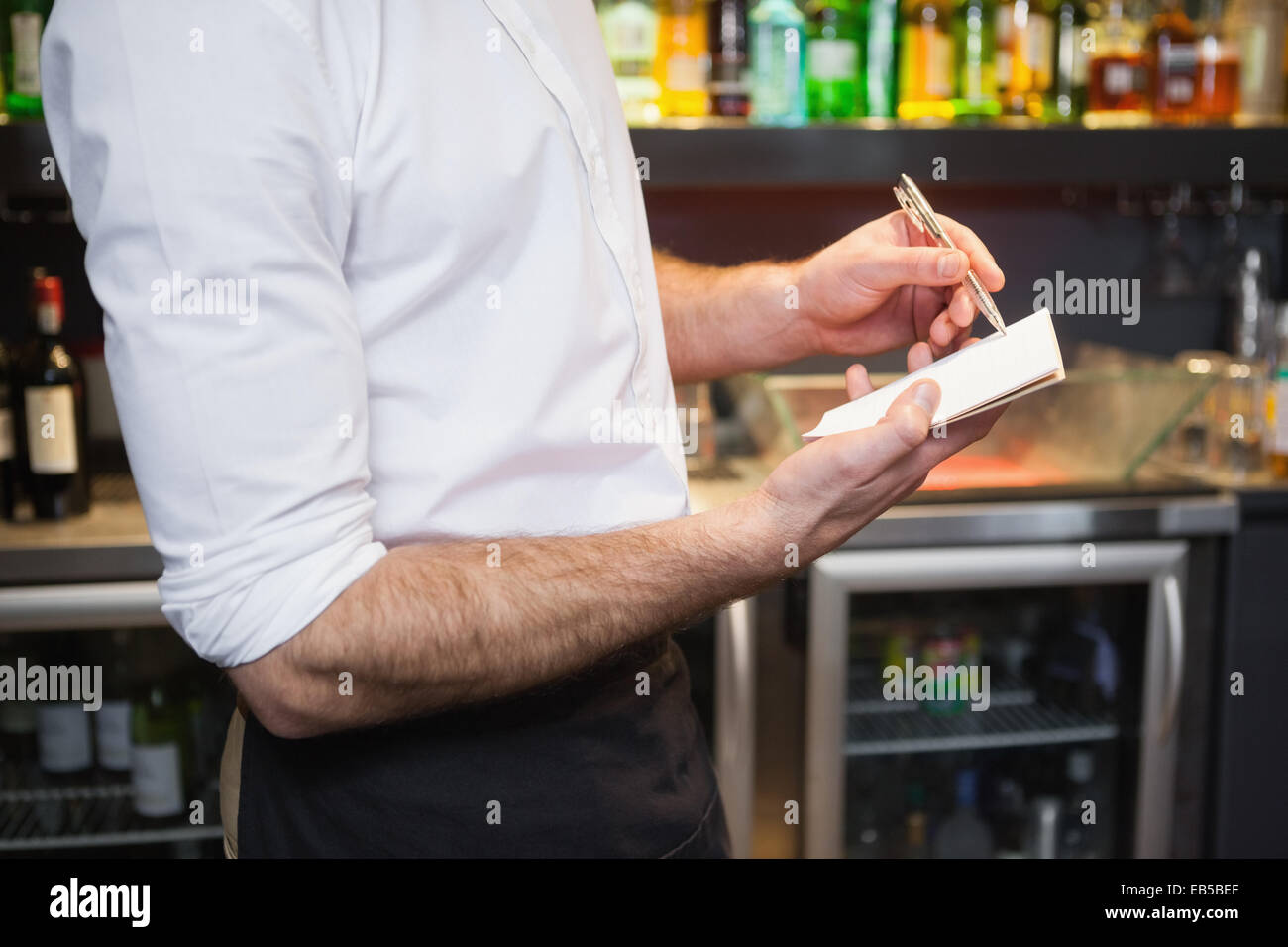 Waiter taking order in his notepad Stock Photo - Alamy