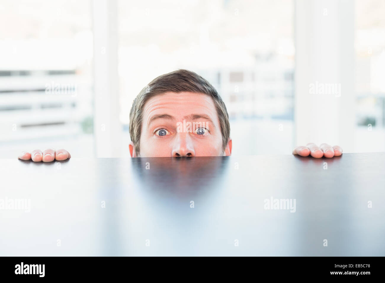 Peeking over desk hi-res stock photography and images - Alamy