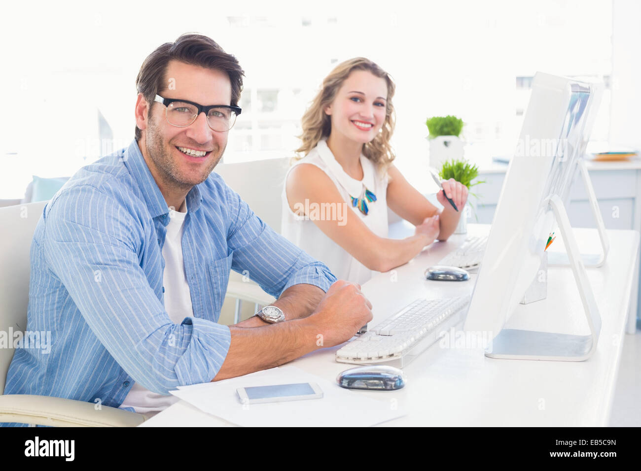 Attractive designers smiling at camera Stock Photo - Alamy Attractive designers smiling at camera Stock Photo - Alamy