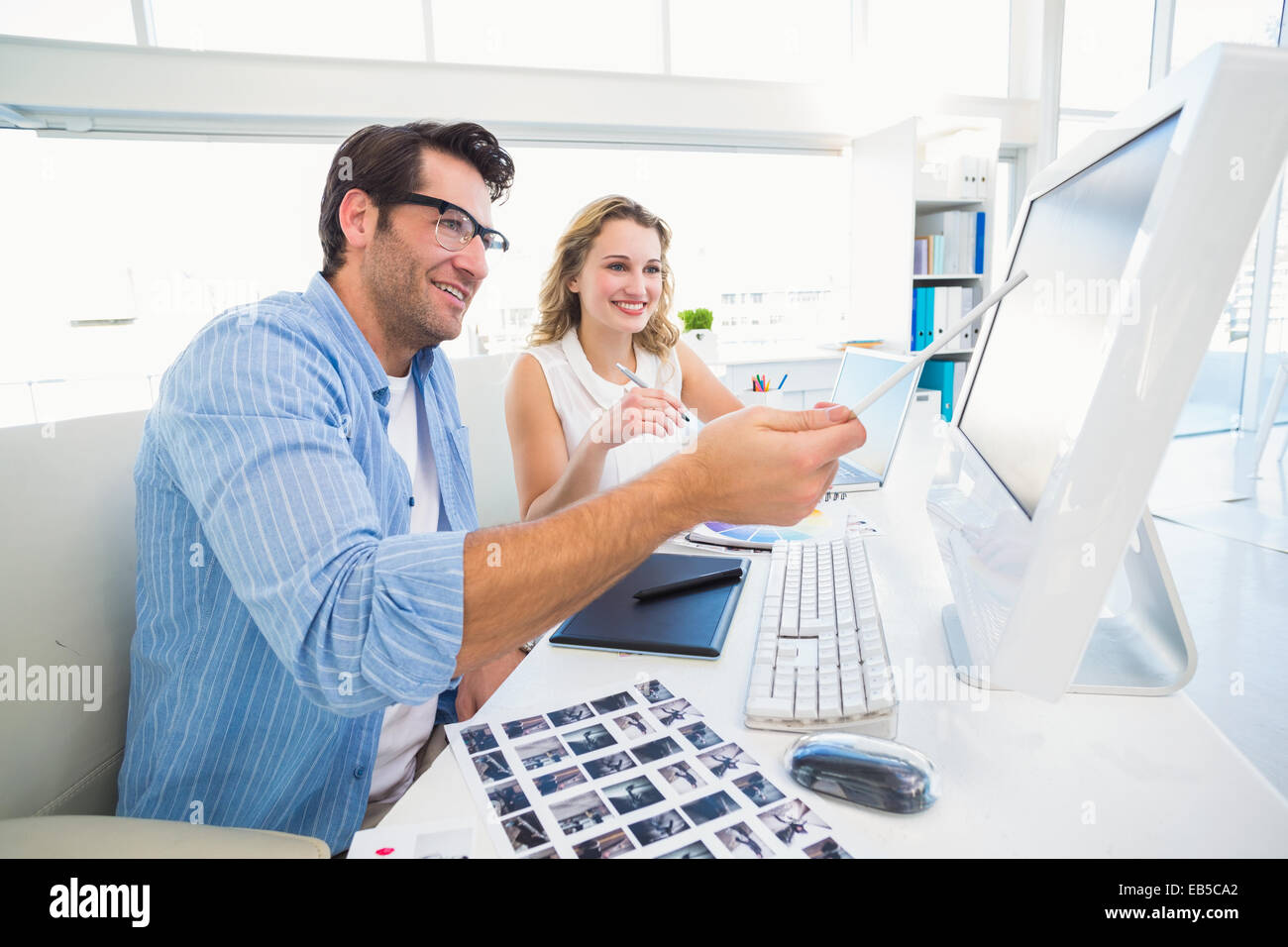 Photo editors working together on graphics tablet Stock Photo - Alamy