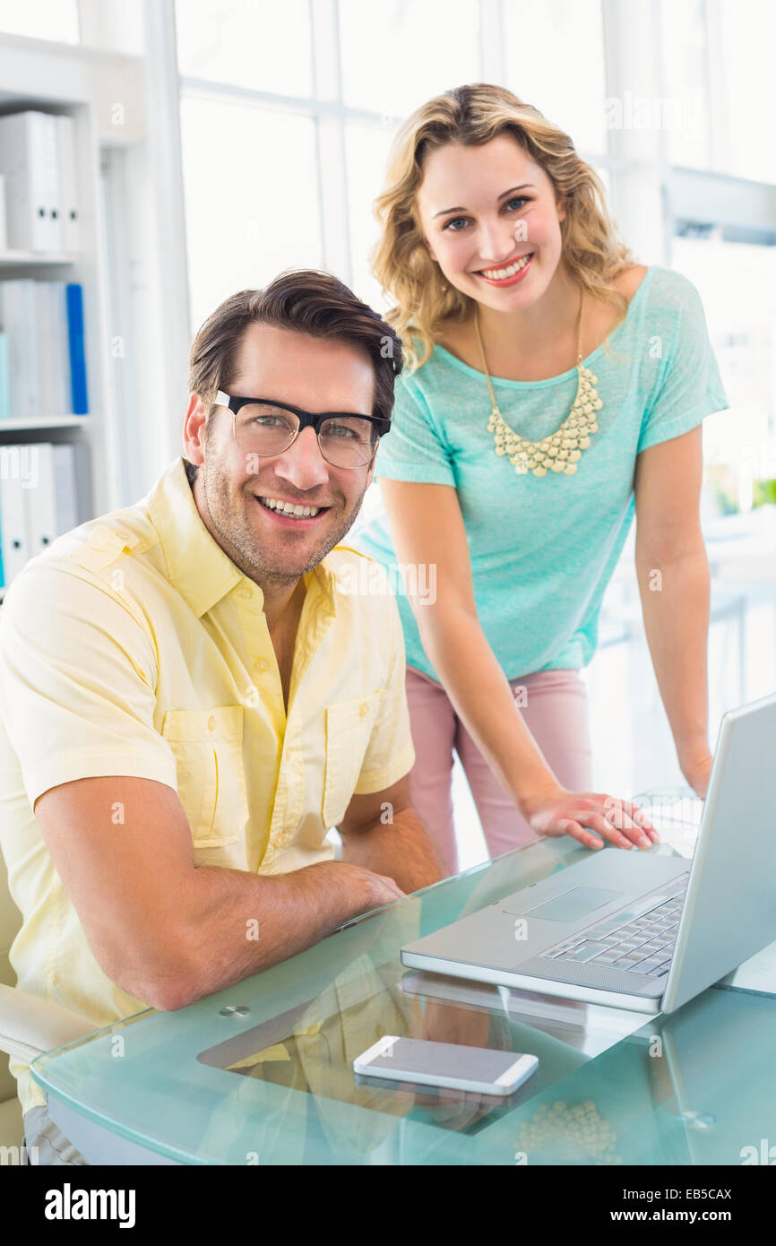 Creative business partners smiling at camera Stock Photo - Alamy