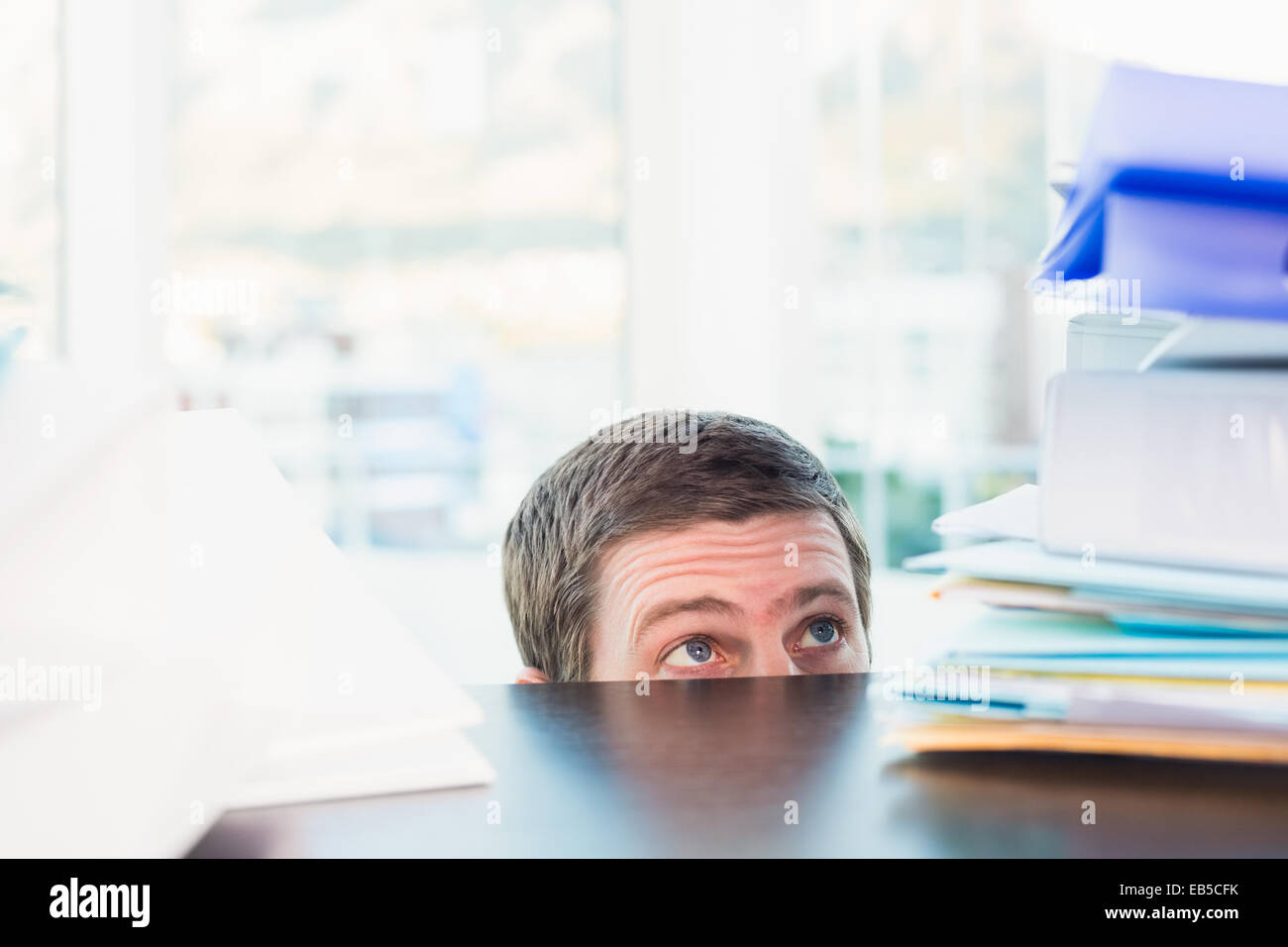 Peeking over desk hi-res stock photography and images - Alamy