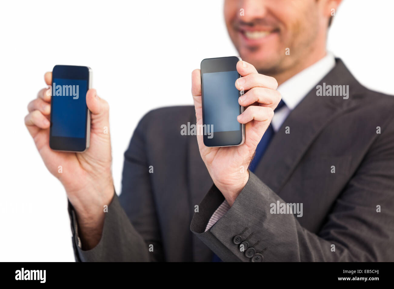 Businessman showing two mobile phone Stock Photo - Alamy