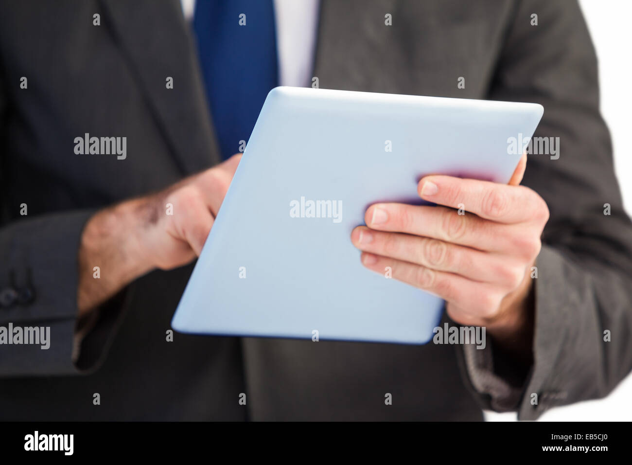 Businessman scrolling on his digital tablet Stock Photo - Alamy