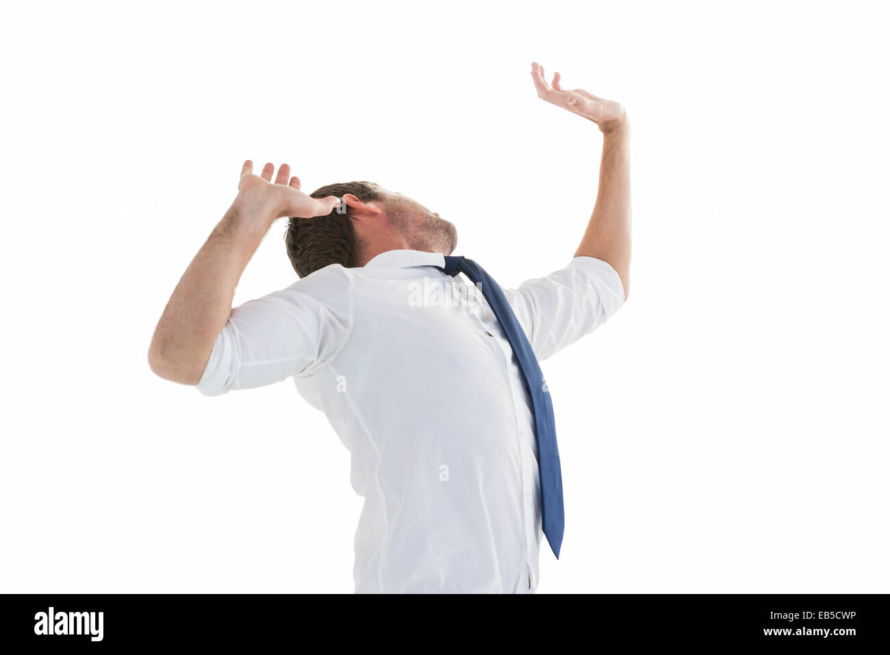 Businessman in suit with hands raised Stock Photo - Alamy