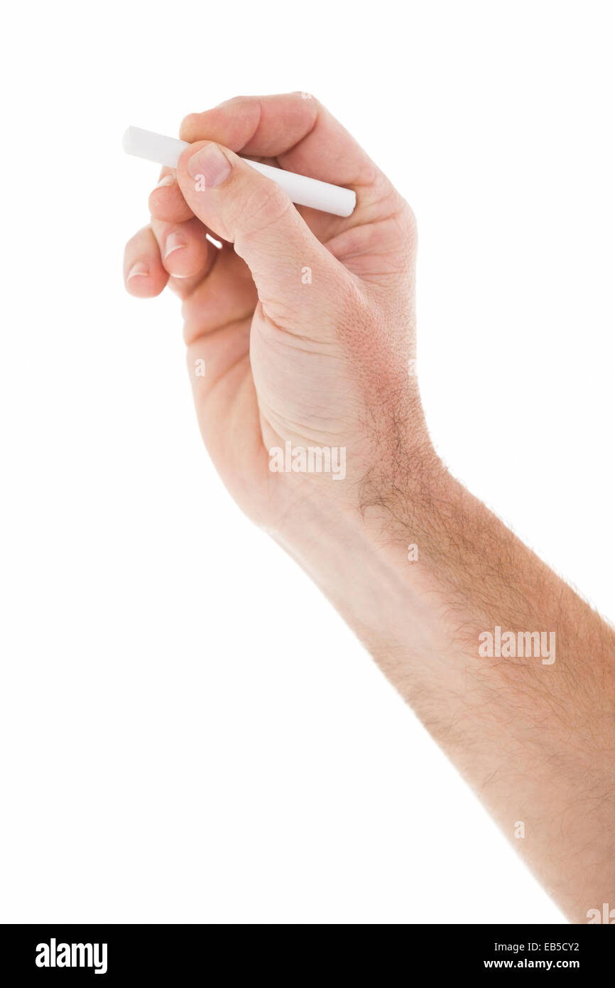 Hand holding a chalk and writing something Stock Photo - Alamy