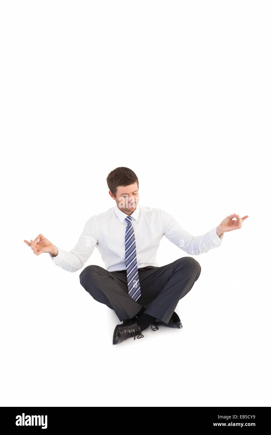 Businessman in suit sitting in lotus pose Stock Photo - Alamy