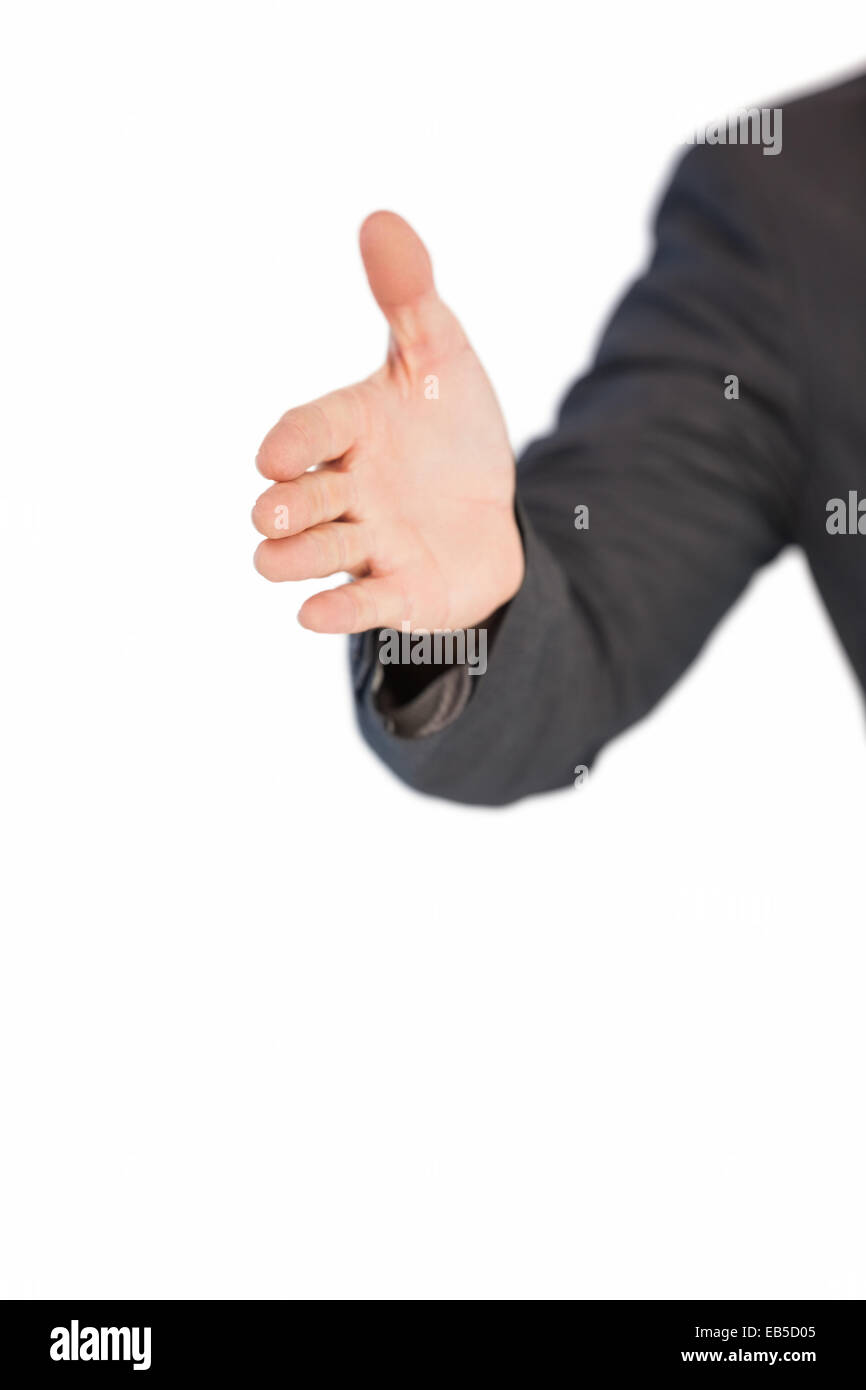 Businessman extending arm for handshake Stock Photo - Alamy