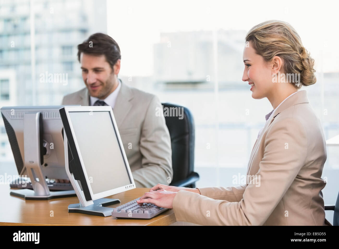Smiling business people using computer Stock Photo - Alamy