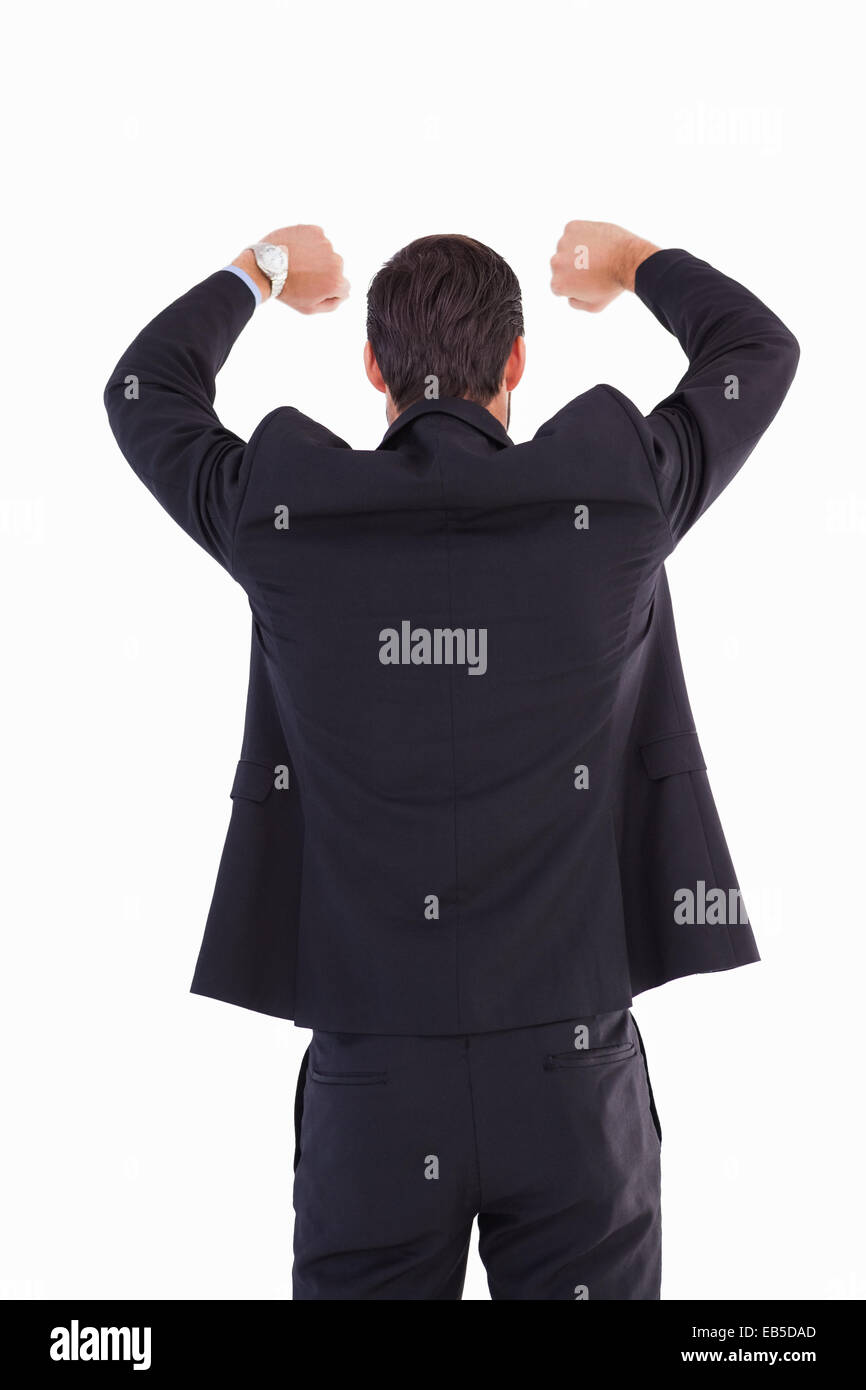 Rear view of businessman standing with arms raised Stock Photo - Alamy