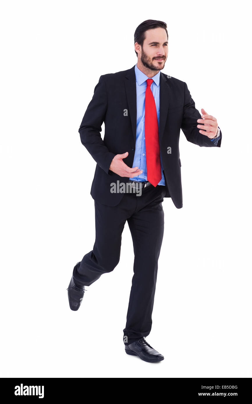 Smiling young businessman in suit running Stock Photo - Alamy
