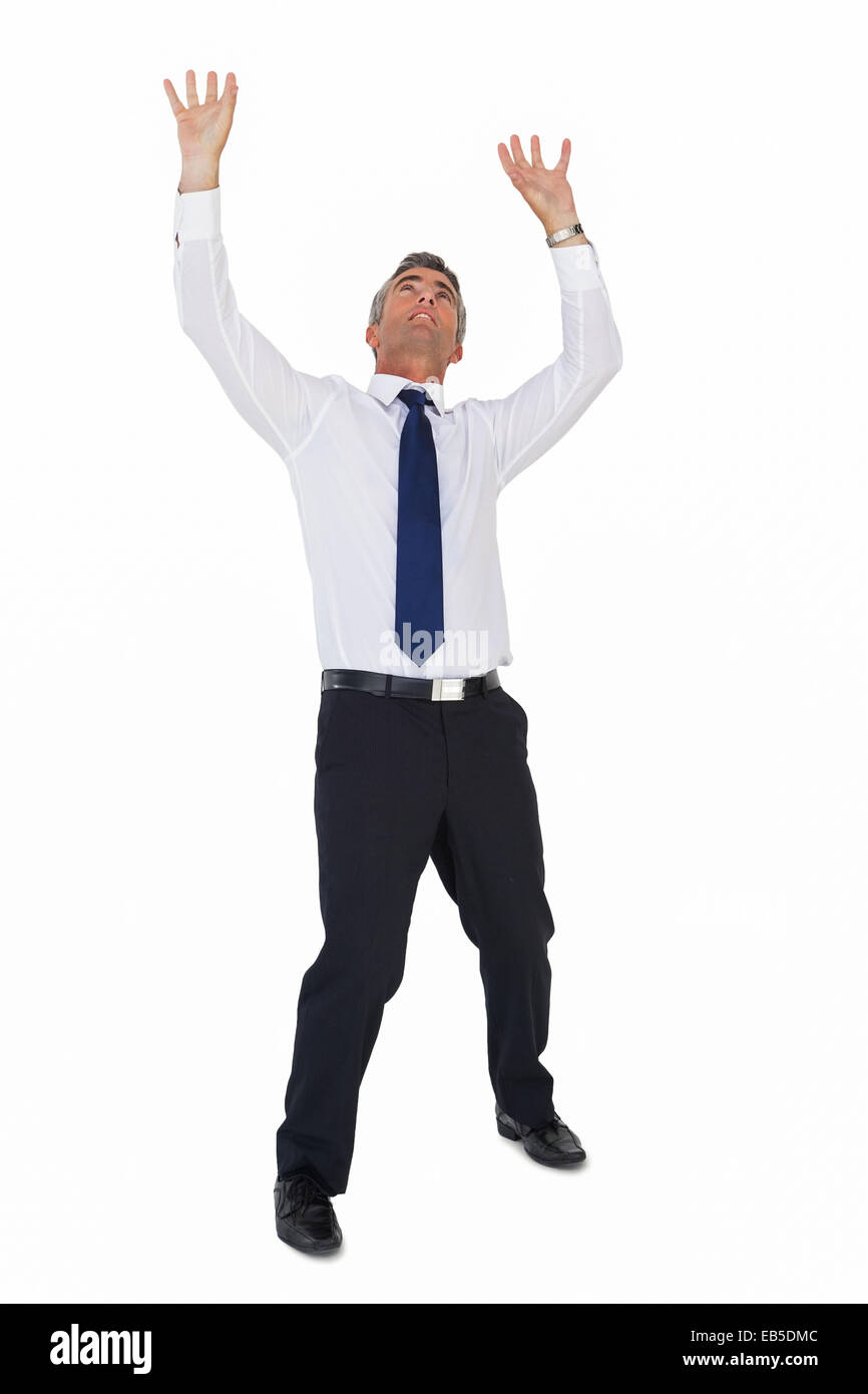 Businessman standing with arms up Stock Photo - Alamy