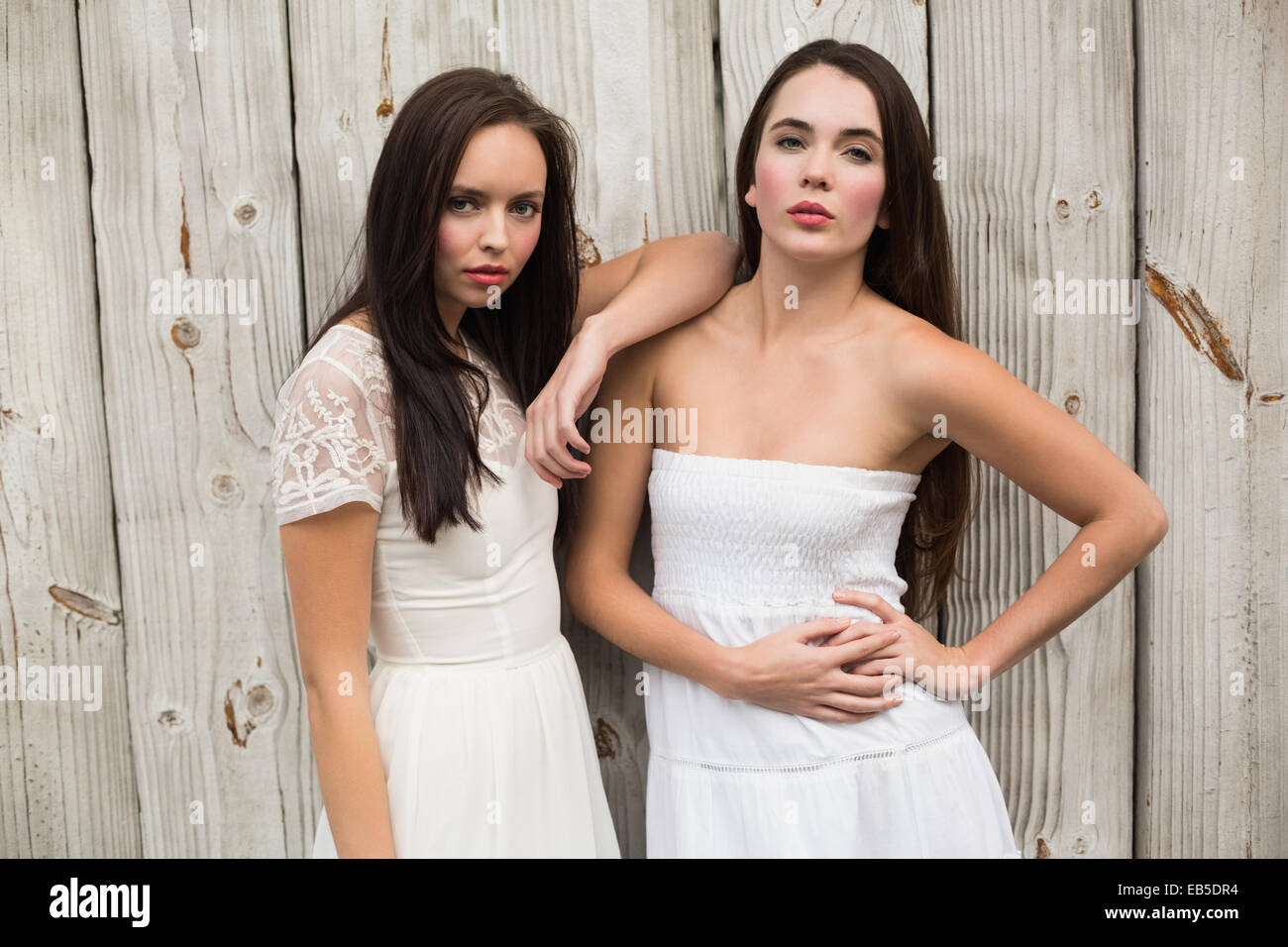 Pretty friends posing in white dresses Stock Photo - Alamy