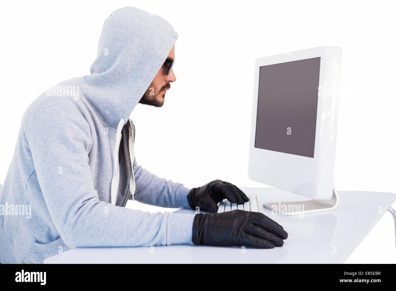 Serious burglar hacking into laptop Stock Photo - Alamy
