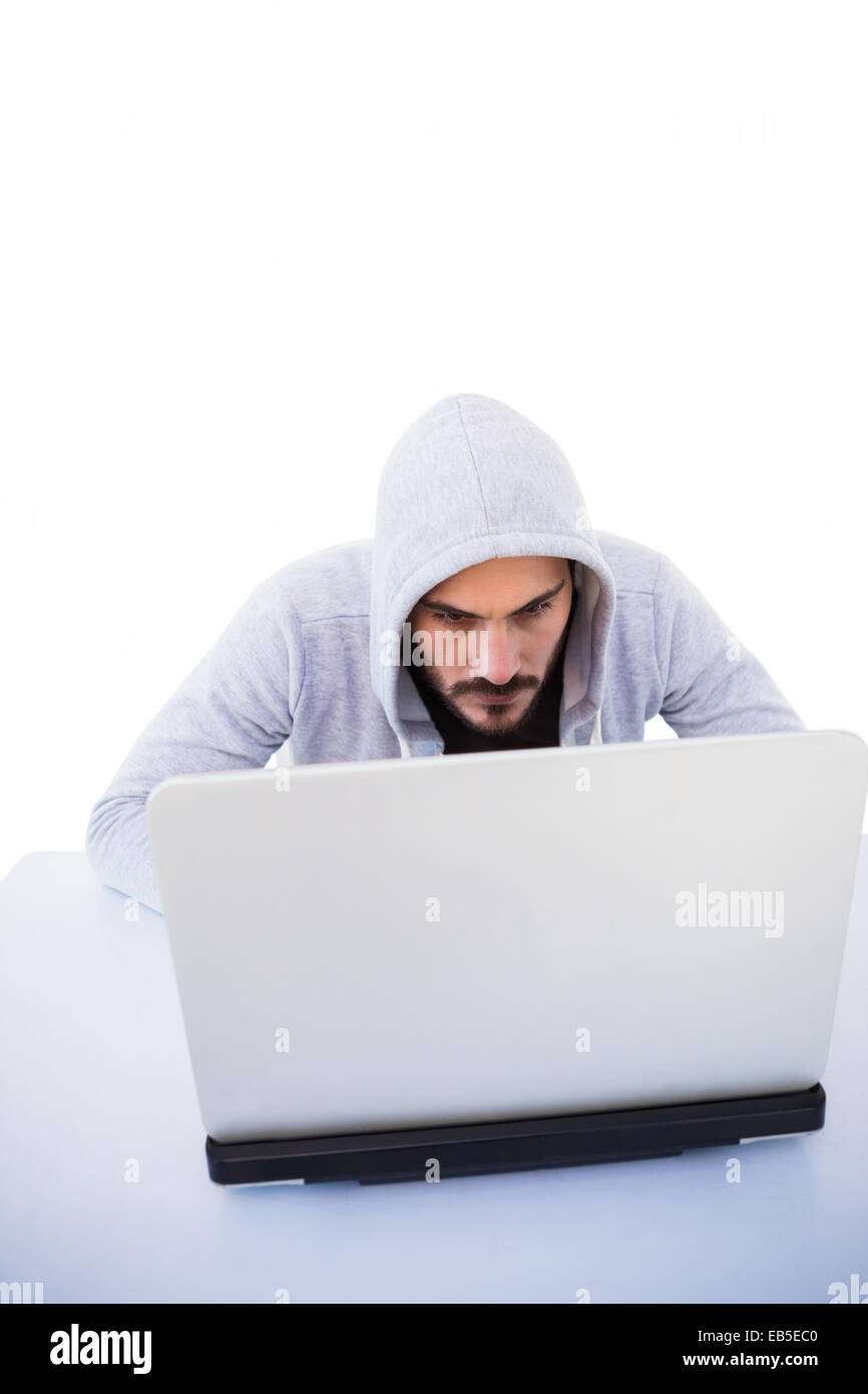 Serious burglar hacking into laptop Stock Photo - Alamy