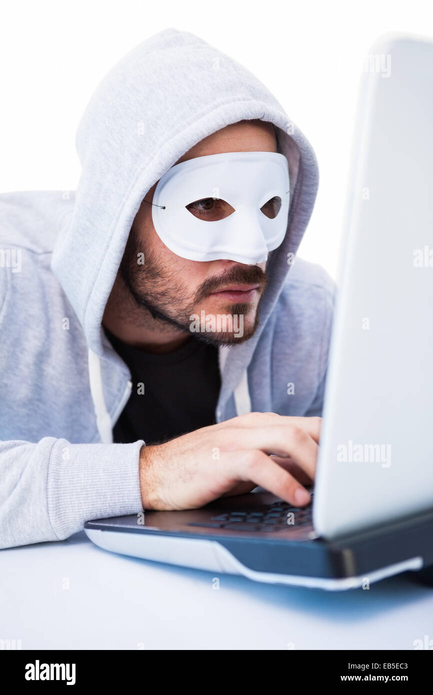 Hacker anonymous mask using laptop hi-res stock photography and images ...
