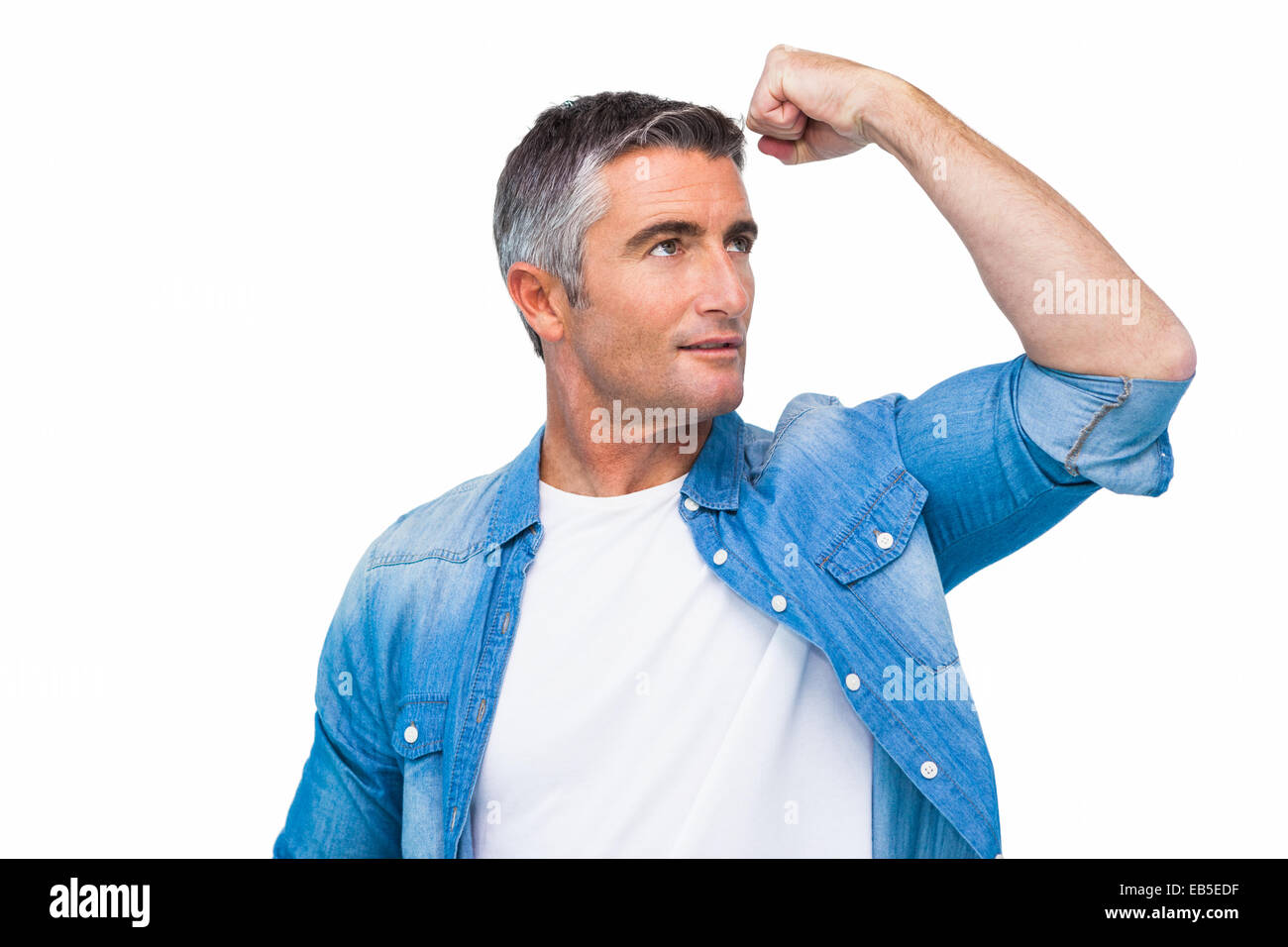 Man with grey hair tensing arm muscle Stock Photo - Alamy