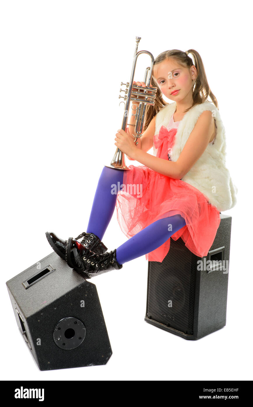 a young and pretty musician is sitting on loudspeakers on white ...
