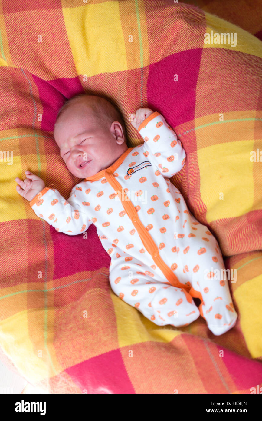 Adorable newborn baby crying alone Stock Photo - Alamy