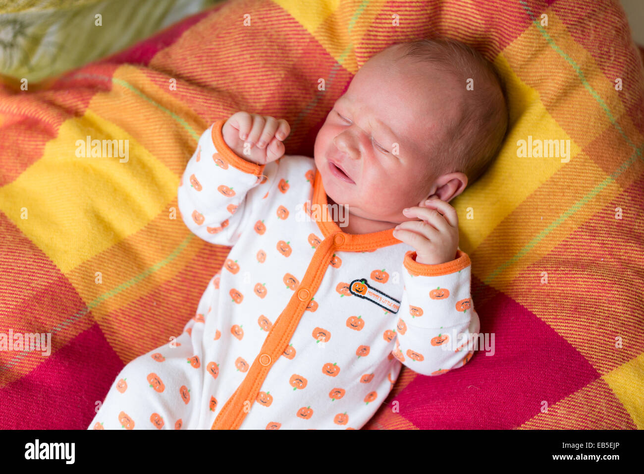 Adorable newborn baby crying alone Stock Photo - Alamy