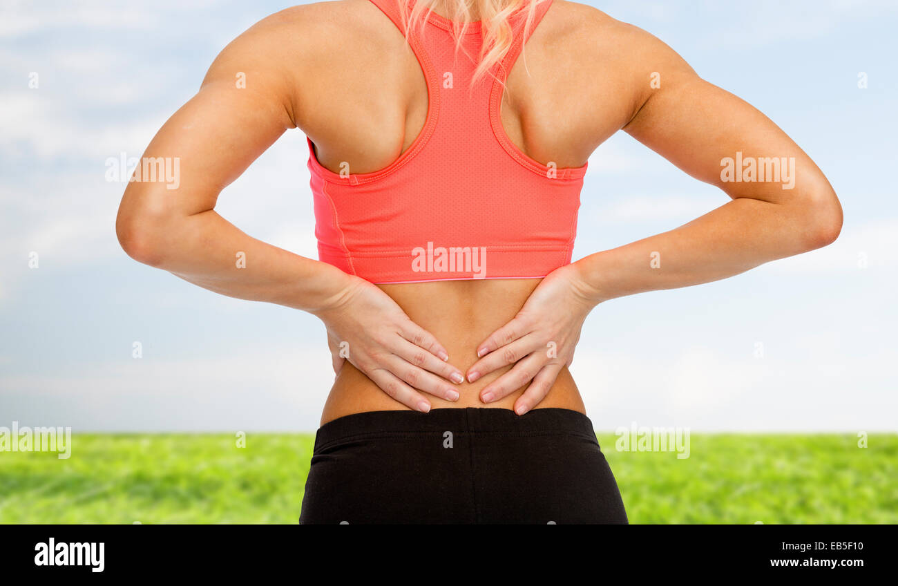close up of sporty woman touching her back Stock Photo - Alamy