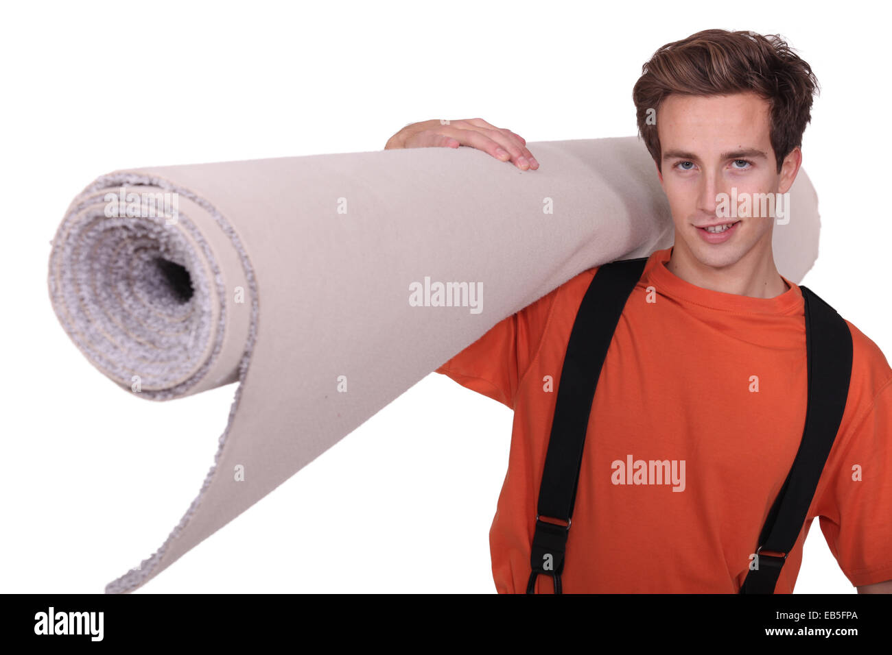 Man carrying a rolled-up carpet Stock Photo - Alamy