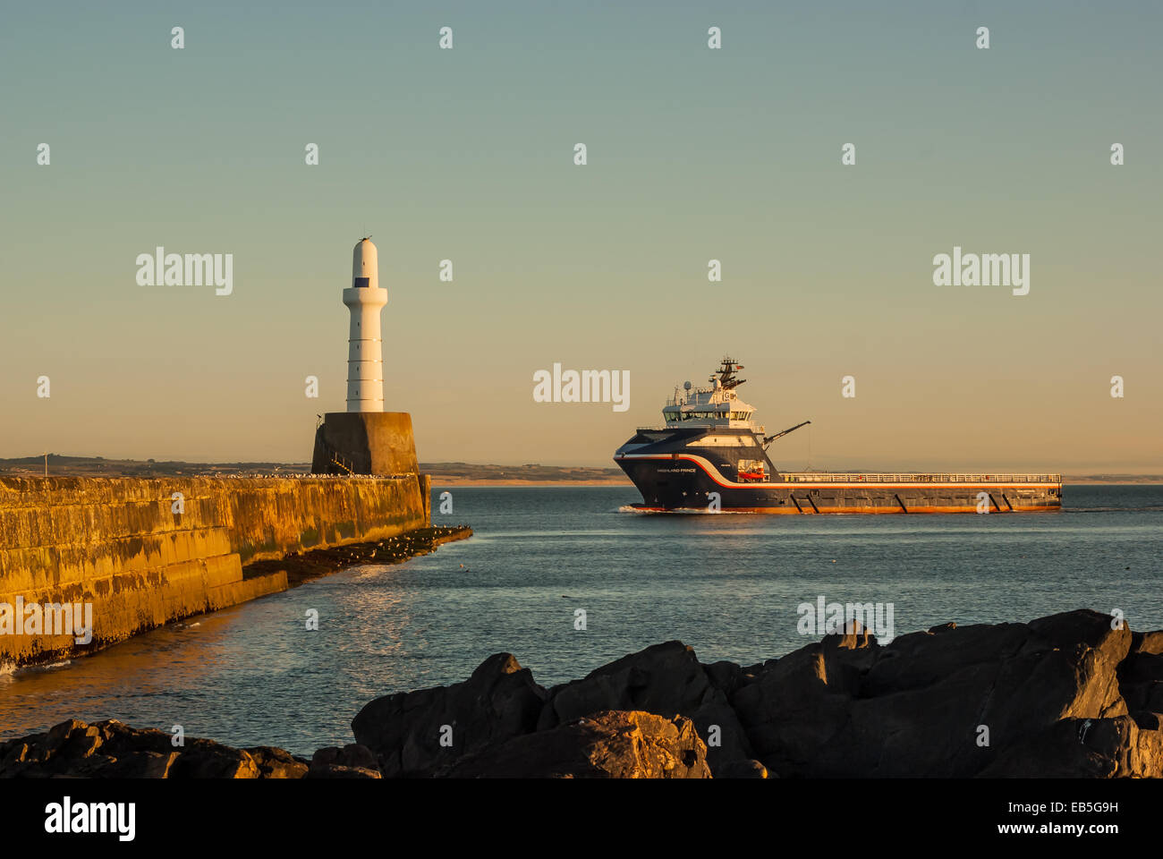 Oil transportation vessel passes lighthouse Stock Photo - Alamy