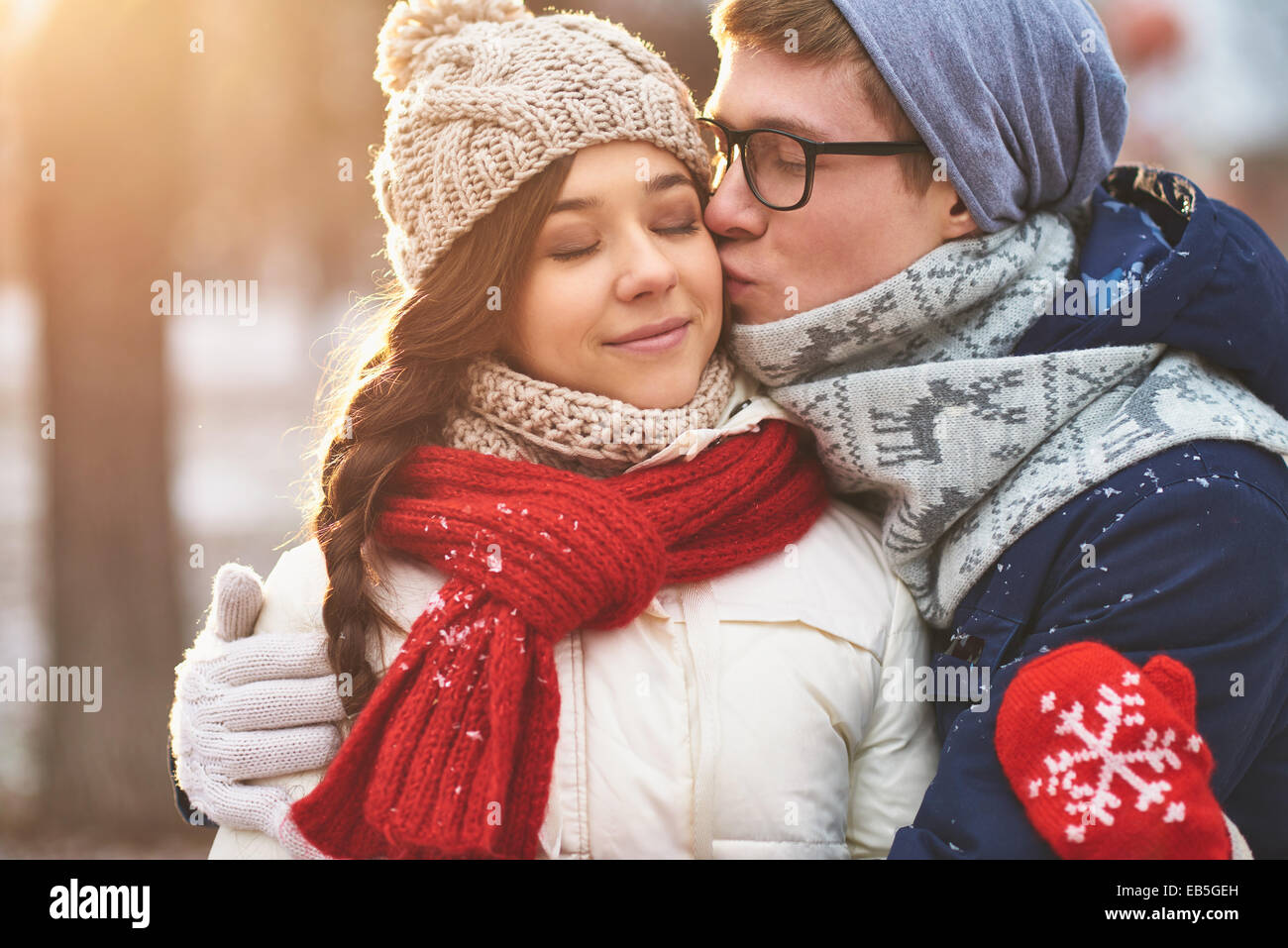 Guy kissing girlfriend on cheek hi-res stock photography and images - Alamy
