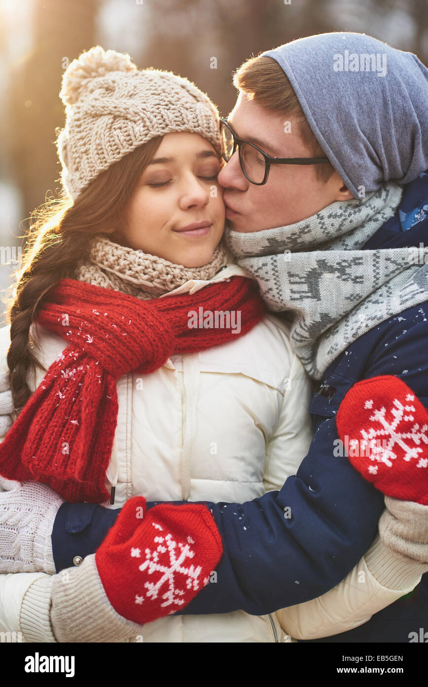 Girl kissing man on cheek hi-res stock photography and images - Alamy