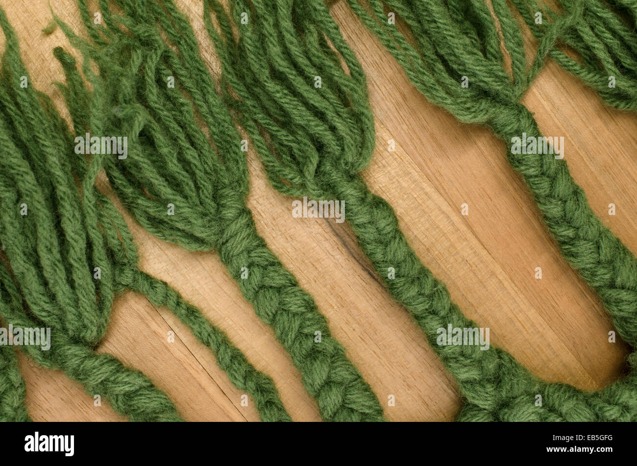 hand made woven wool braids on a wood surface close up Stock Photo - Alamy
