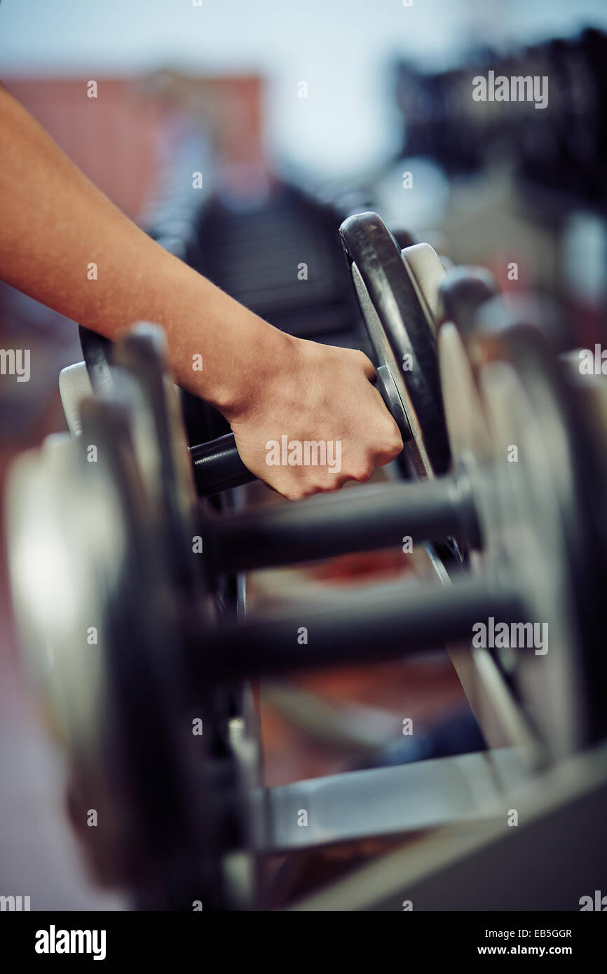 Female hand taking a dumbbell Stock Photo - Alamy