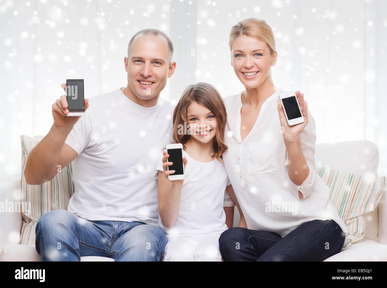 happy family showing smartphones blank screens Stock Photo - Alamy