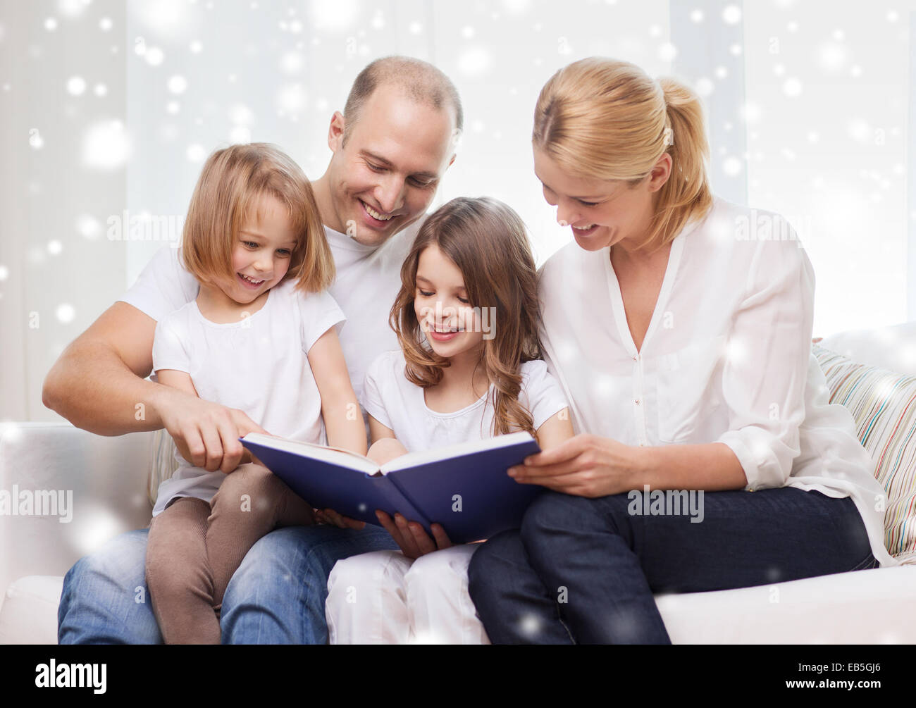 happy family with book at home Stock Photo - Alamy