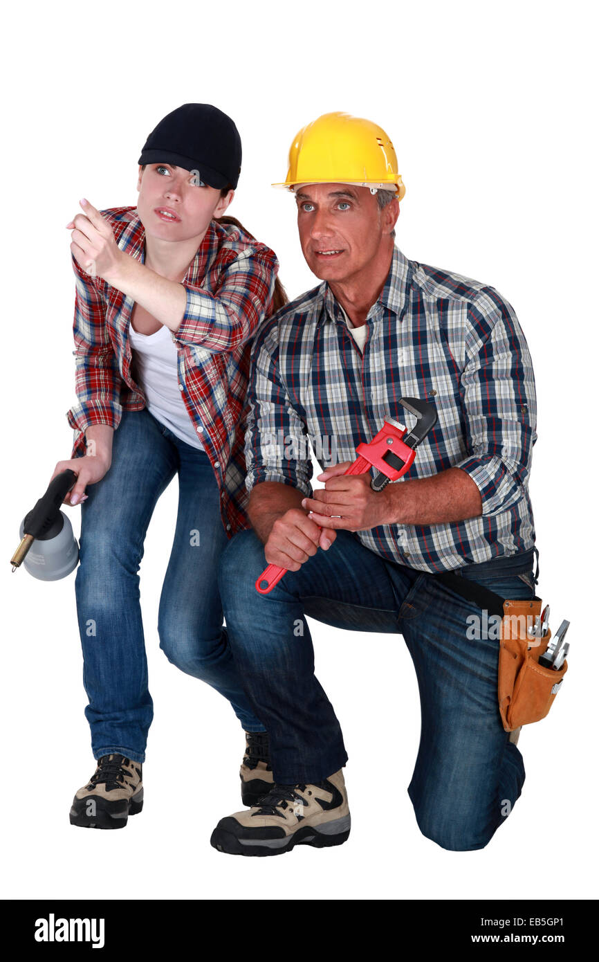 Male and female workers crouching Stock Photo - Alamy